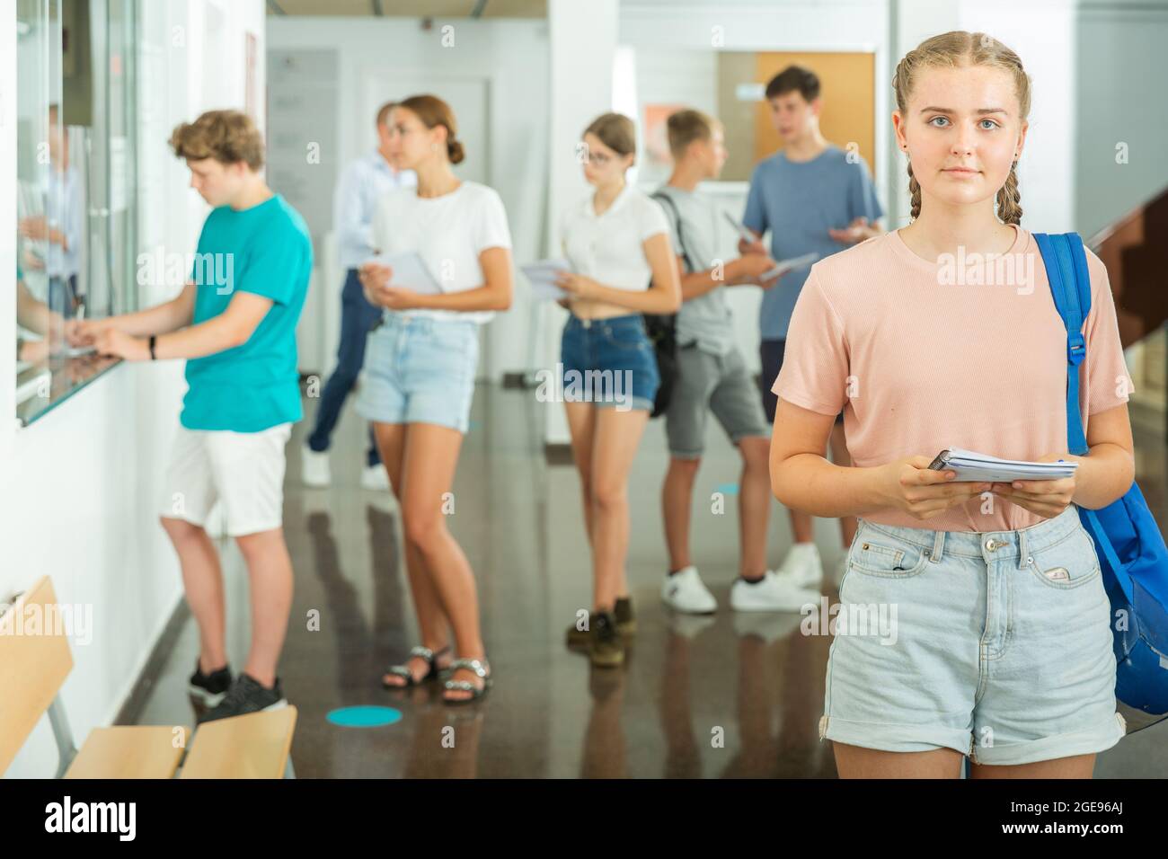 Confident interested teenage girl student standing with backpack and ...