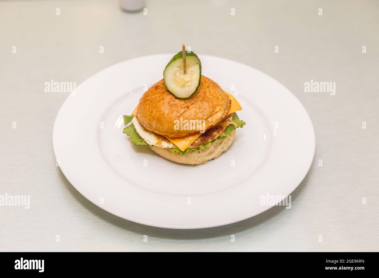 Delicious served burger in white plate Stock Photo - Alamy