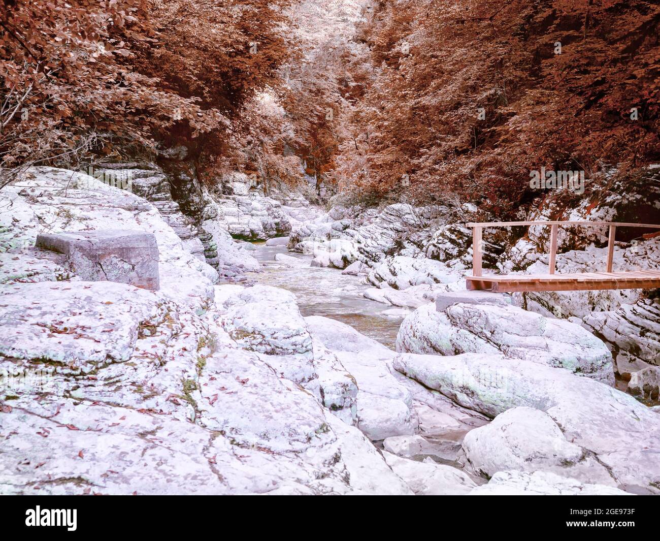 A terrain of smooth rounded rocks with river flowing between them and ...