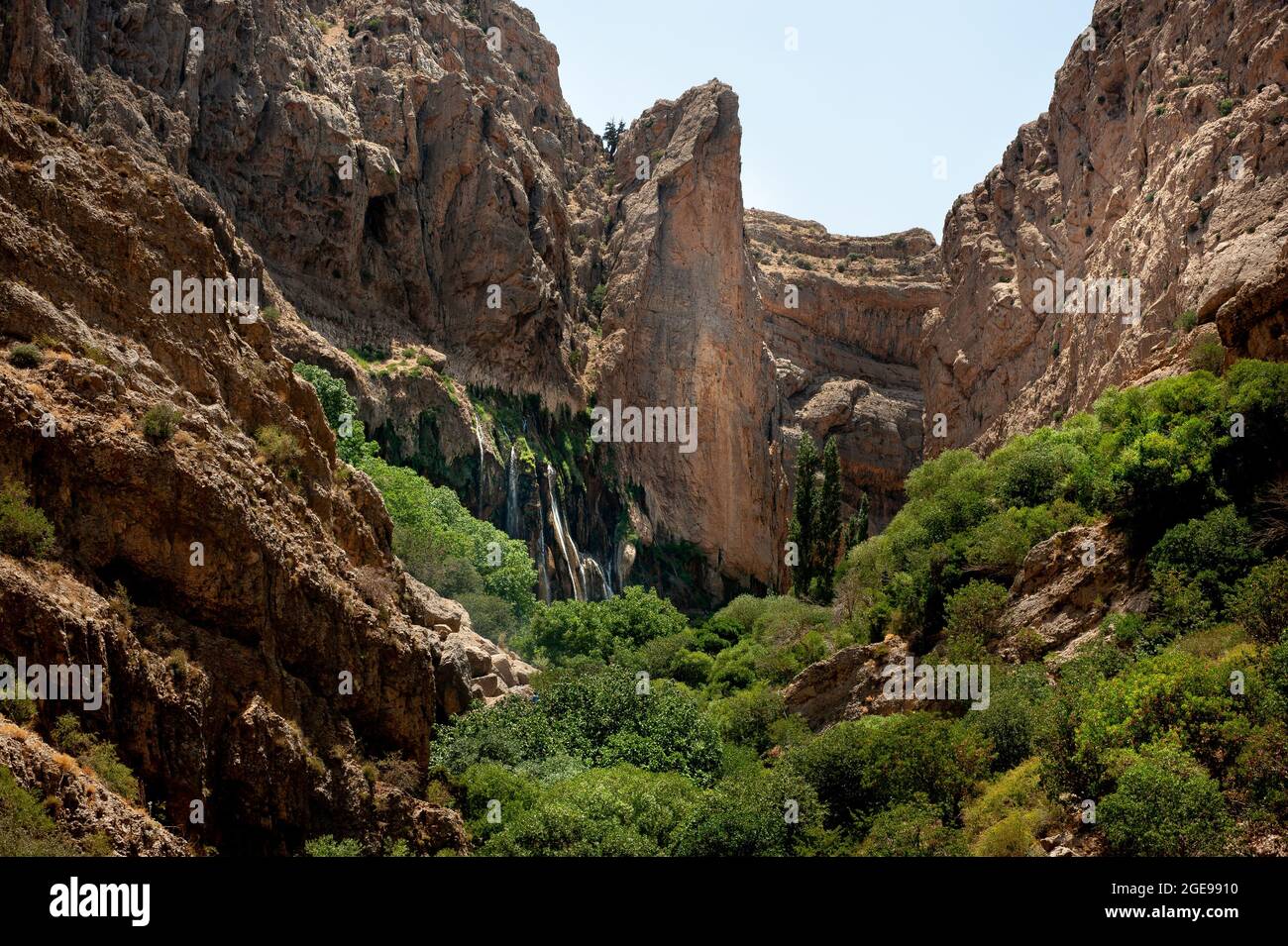 Margoon waterfall in iran. View of tall waterfall surrounded mountains ...