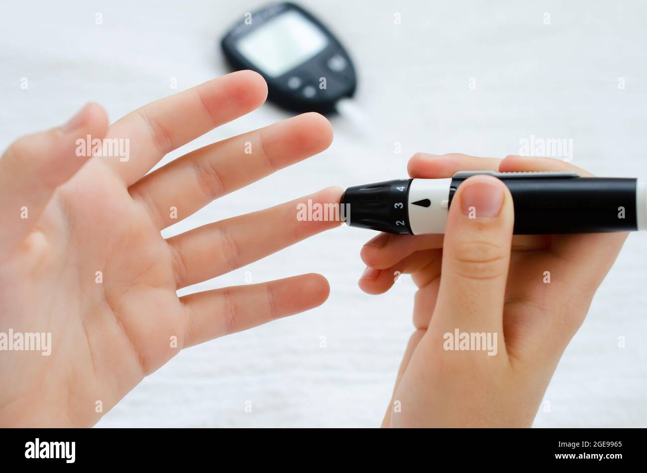 Child Hands Using Lancet on Finger to Check Blood Sugar Level by ...