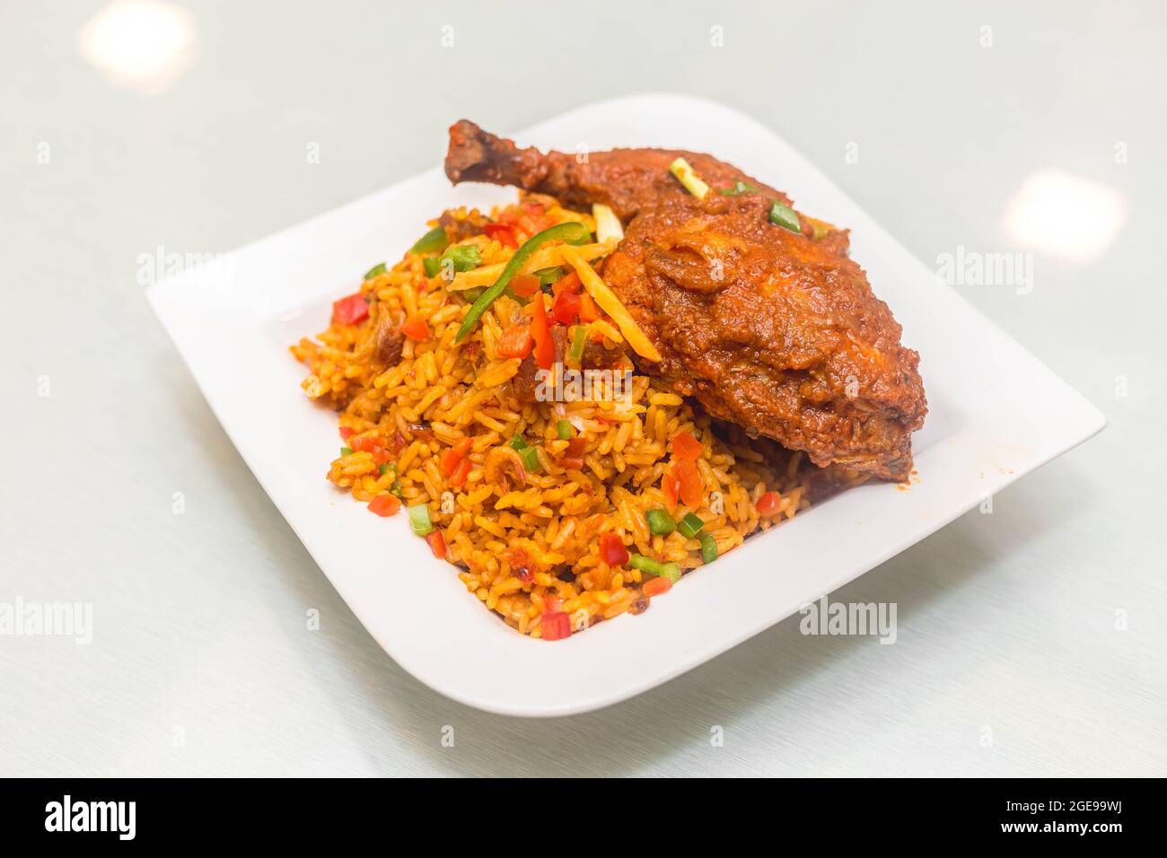 Jollof rice and chicken with salad Stock Photo - Alamy