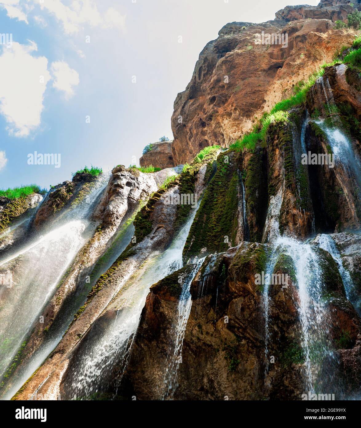 Margoon waterfall in iran. View of tall waterfall surrounded mountains ...