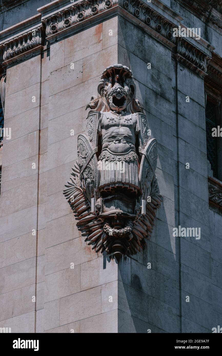 Vertical shot of a sculpture on the external corner wall of a ...