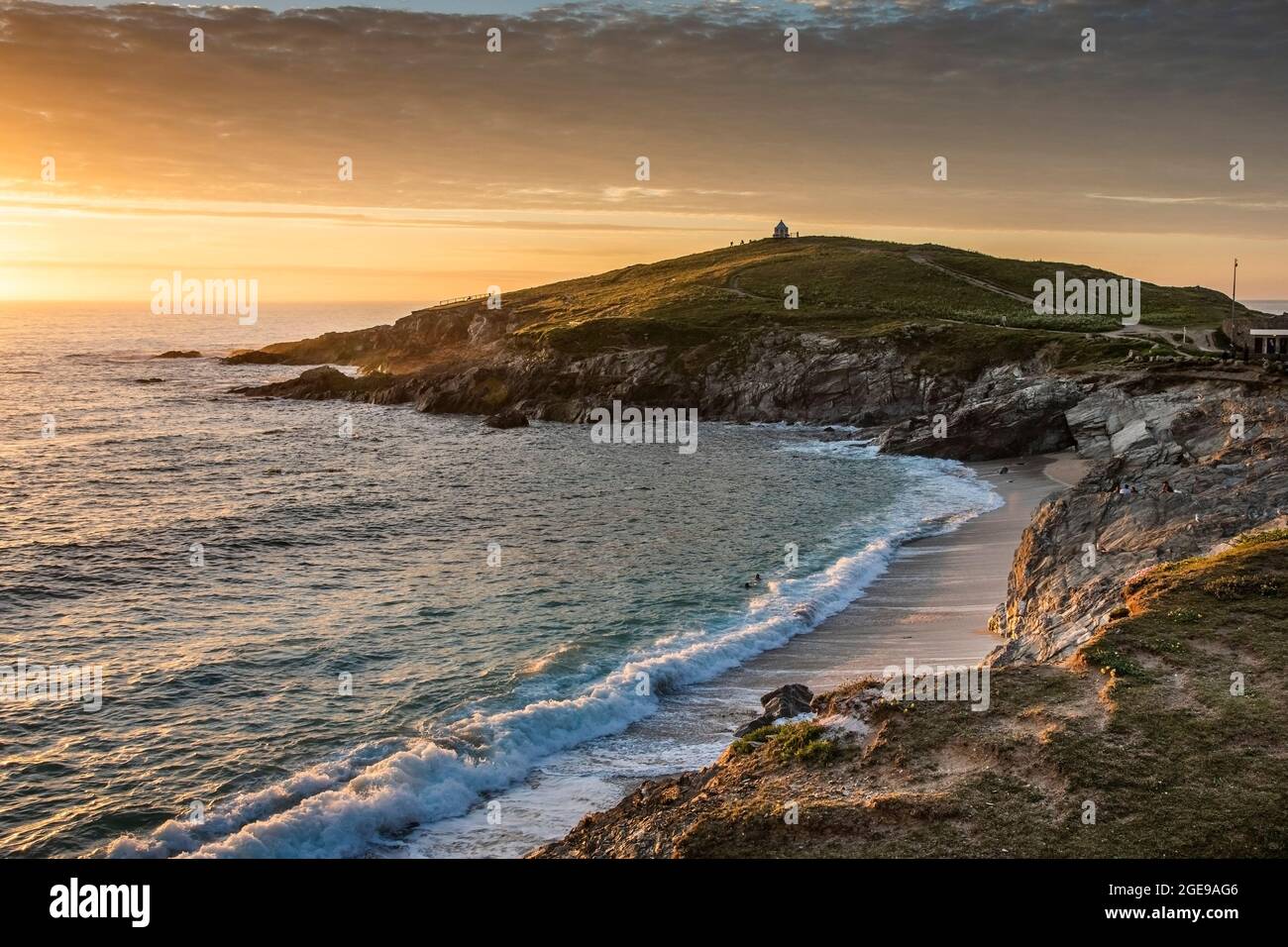 Golden light of an intense sunset over Towan Head on the coast of ...