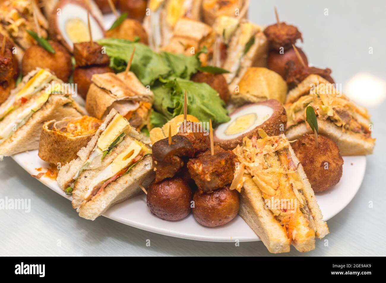 Combo meals consisting sliced cakes, scotch egg, small chops with ...