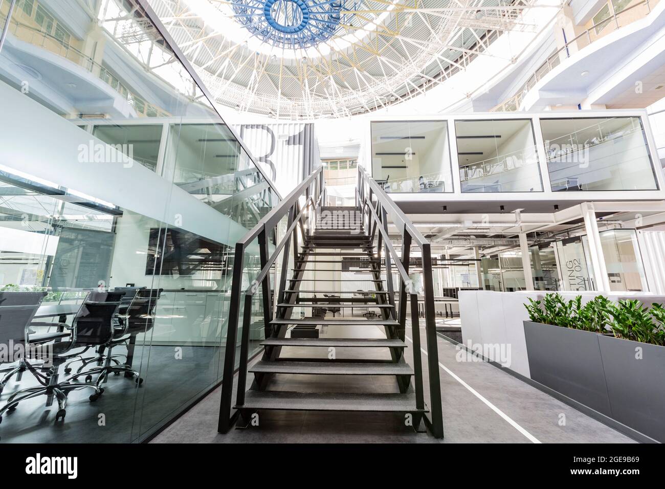 Two-floor business center with individual work cabinets and metal ...
