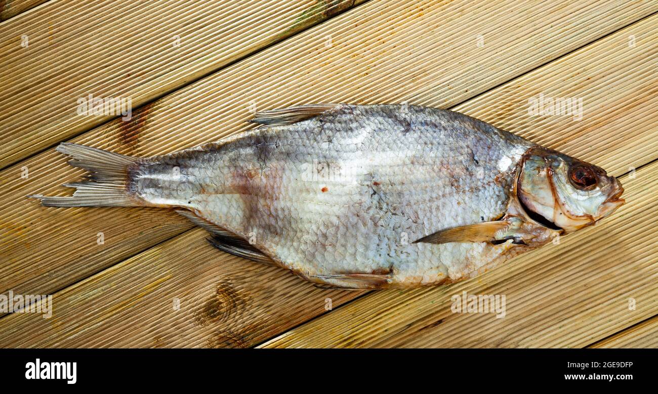 Whole dried salted bream fish on wooden background. Beer snack Stock ...