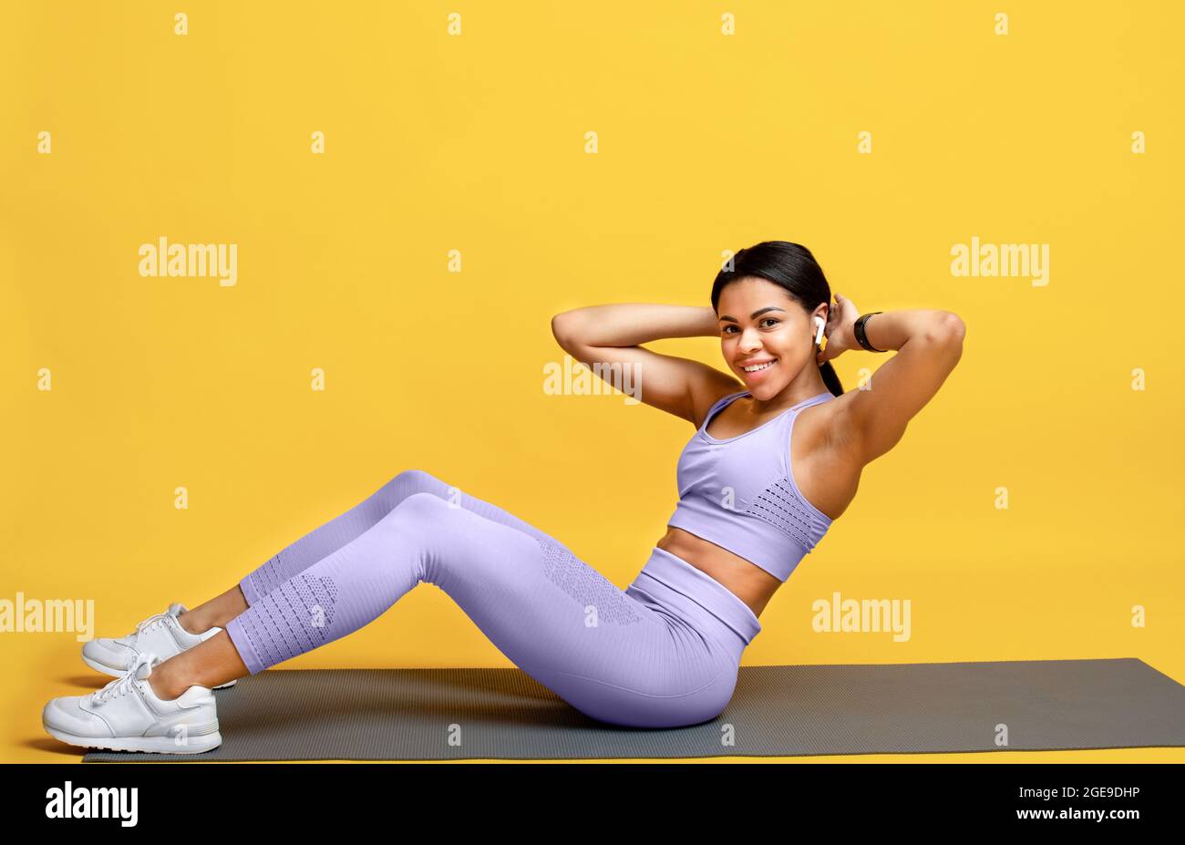 Millennial african american woman doing abs exercises on sports mat ...
