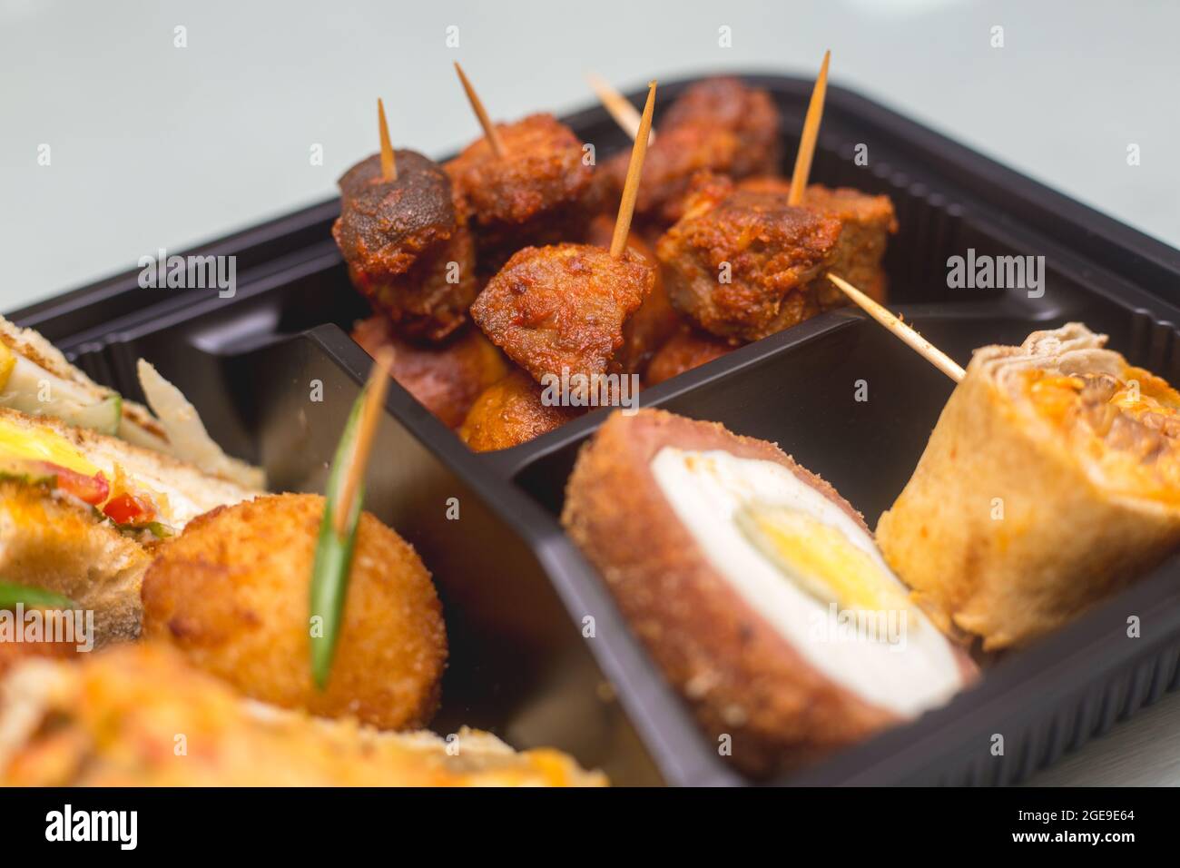 Combo meals consisting sliced cakes, scotch egg, small chops with ...