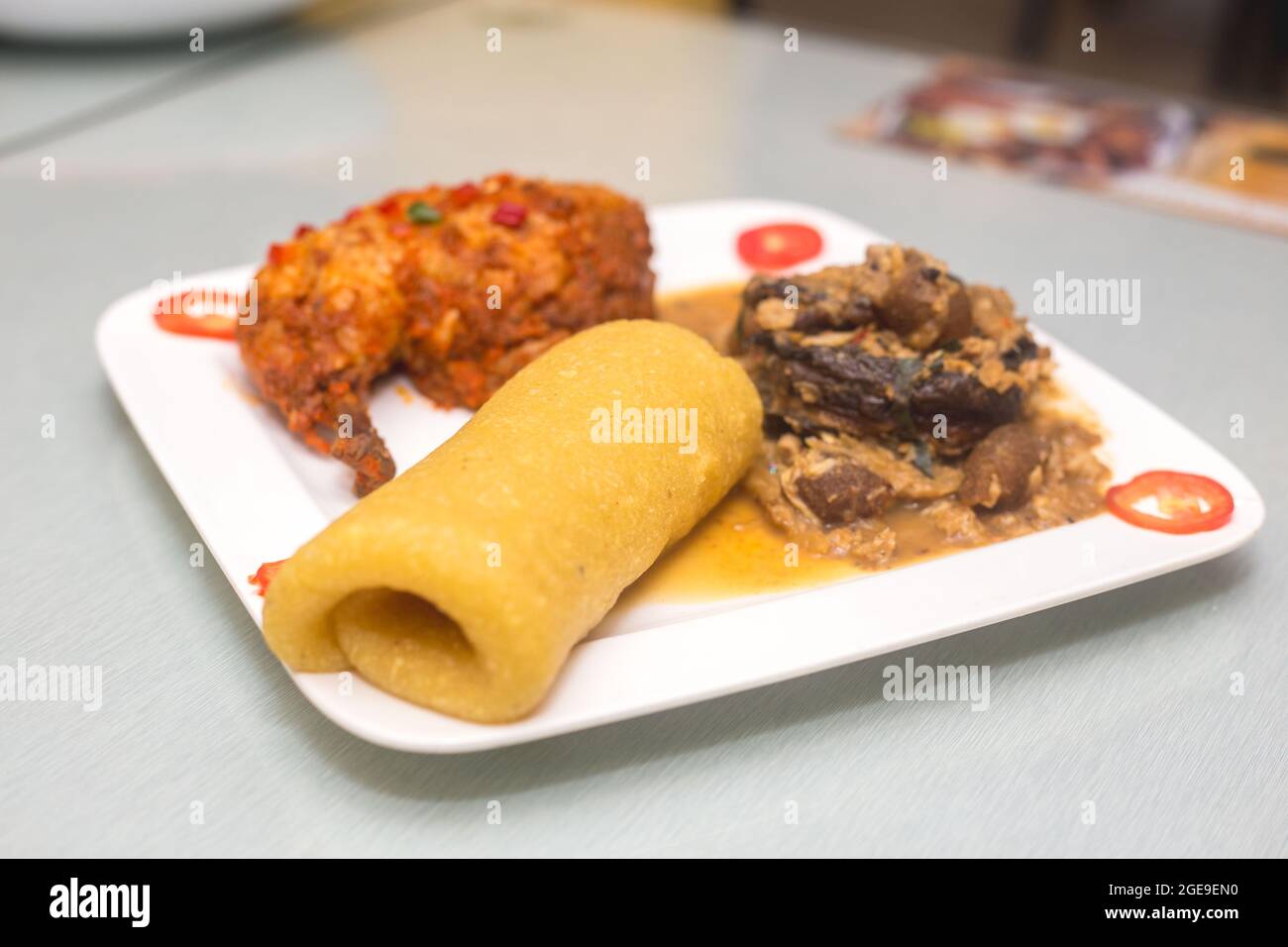 Eba (cassava flour garri) and white soup with chicken Stock Photo - Alamy
