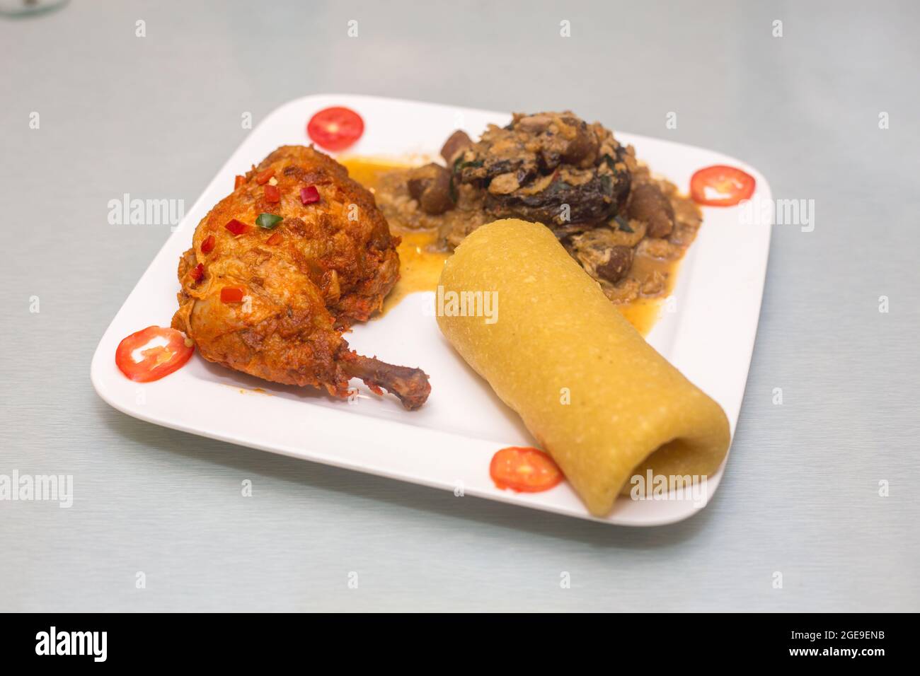 Eba (cassava flour garri) and white soup with chicken Stock Photo - Alamy