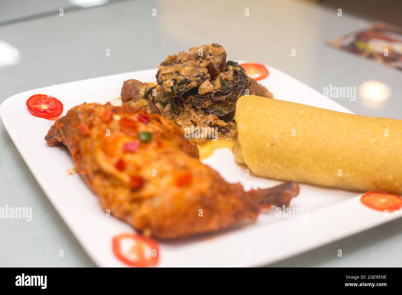 Eba (cassava flour garri) and white soup with chicken Stock Photo - Alamy