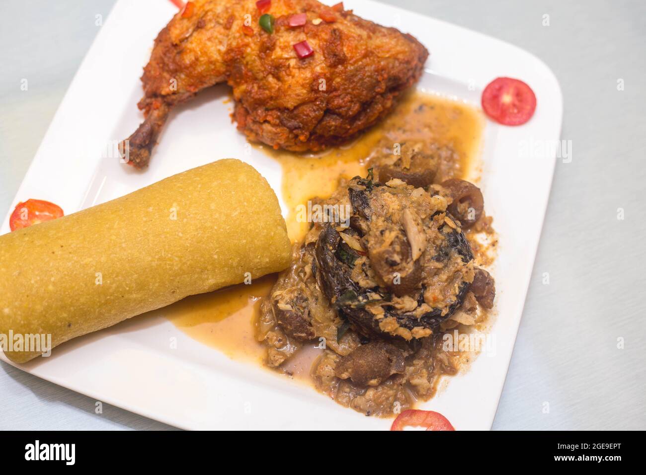 Eba (cassava flour garri) and white soup with chicken Stock Photo - Alamy