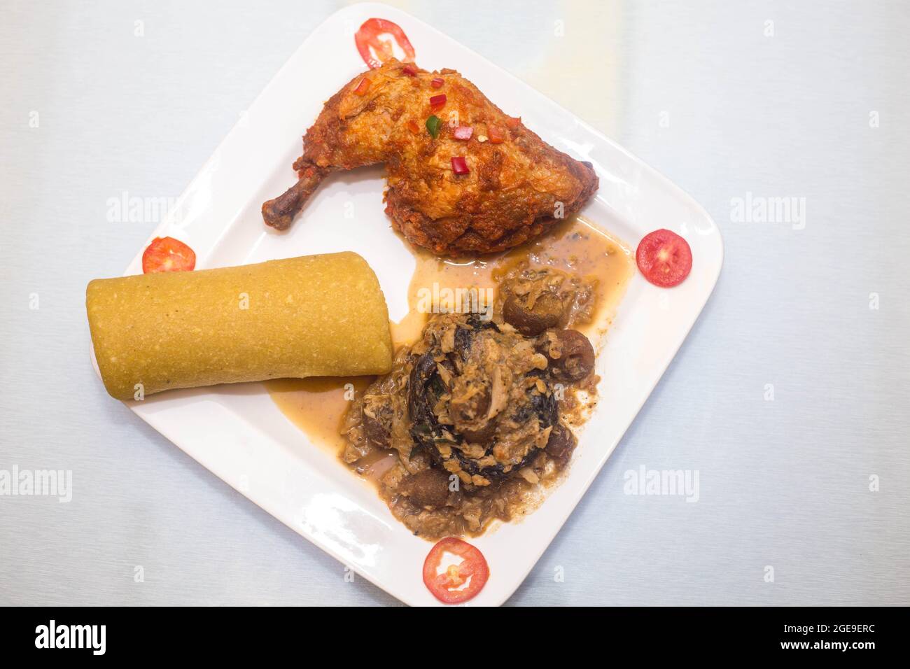 Eba (cassava flour garri) and white soup with chicken Stock Photo - Alamy