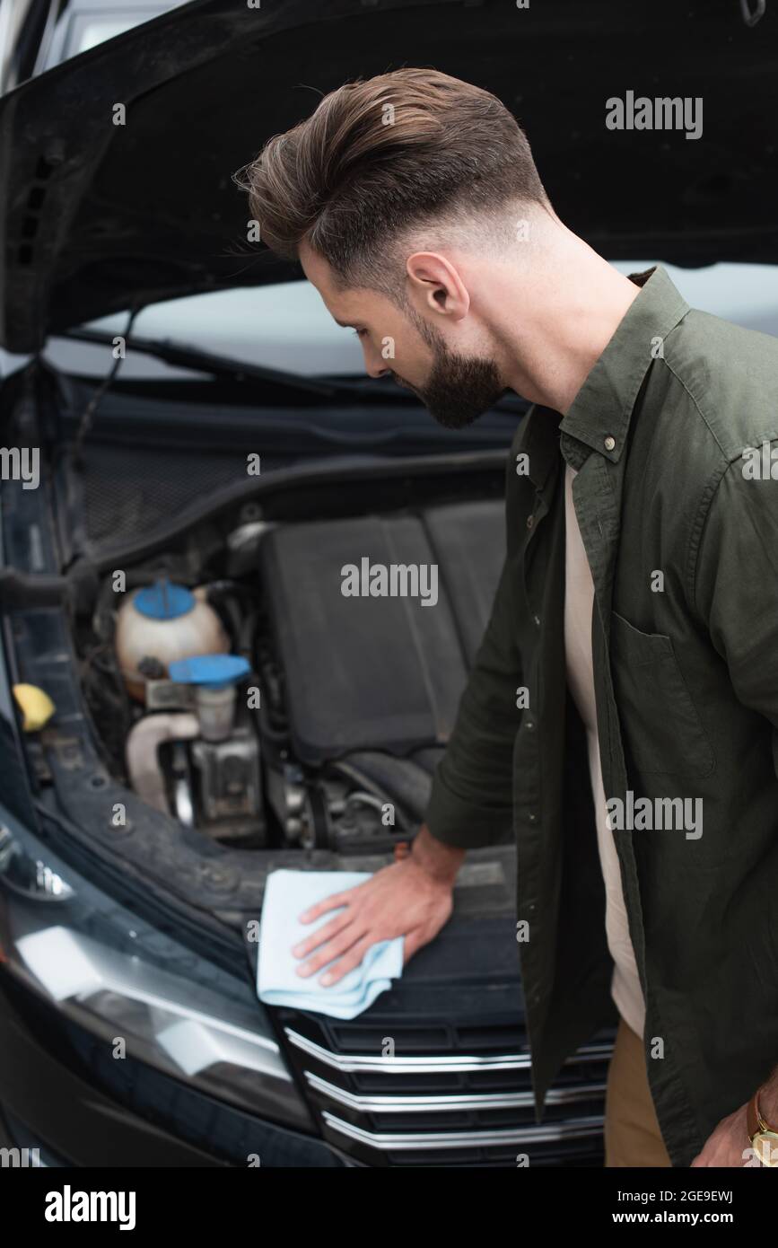 Side view of driver with rag cleaning car Stock Photo - Alamy