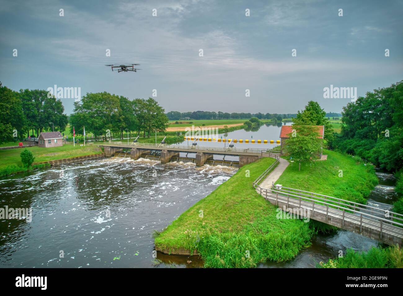 An aerial view with drone in the background above a weir in the river ...