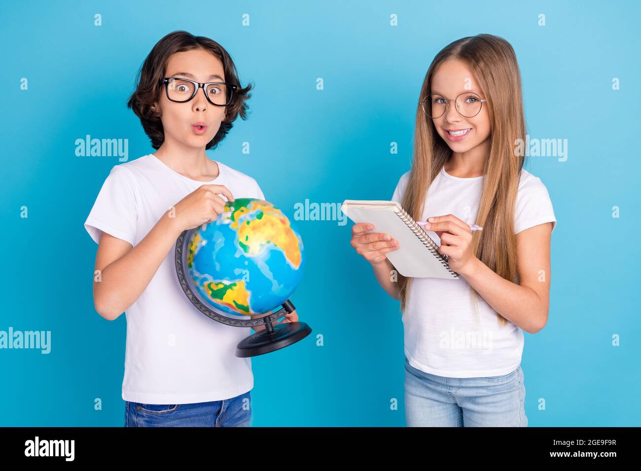 Photo of shocked kids boy hold globe girl take notes wear glasses white ...