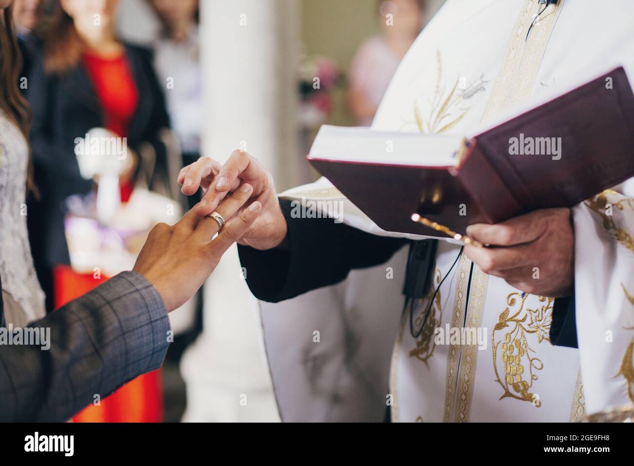 Putting wedding ring on finger during wedding ceremony hi-res stock ...
