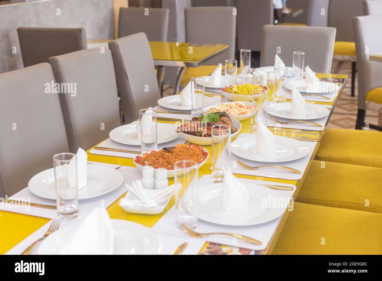 Dinning set up of African meals with jollof rice Stock Photo - Alamy