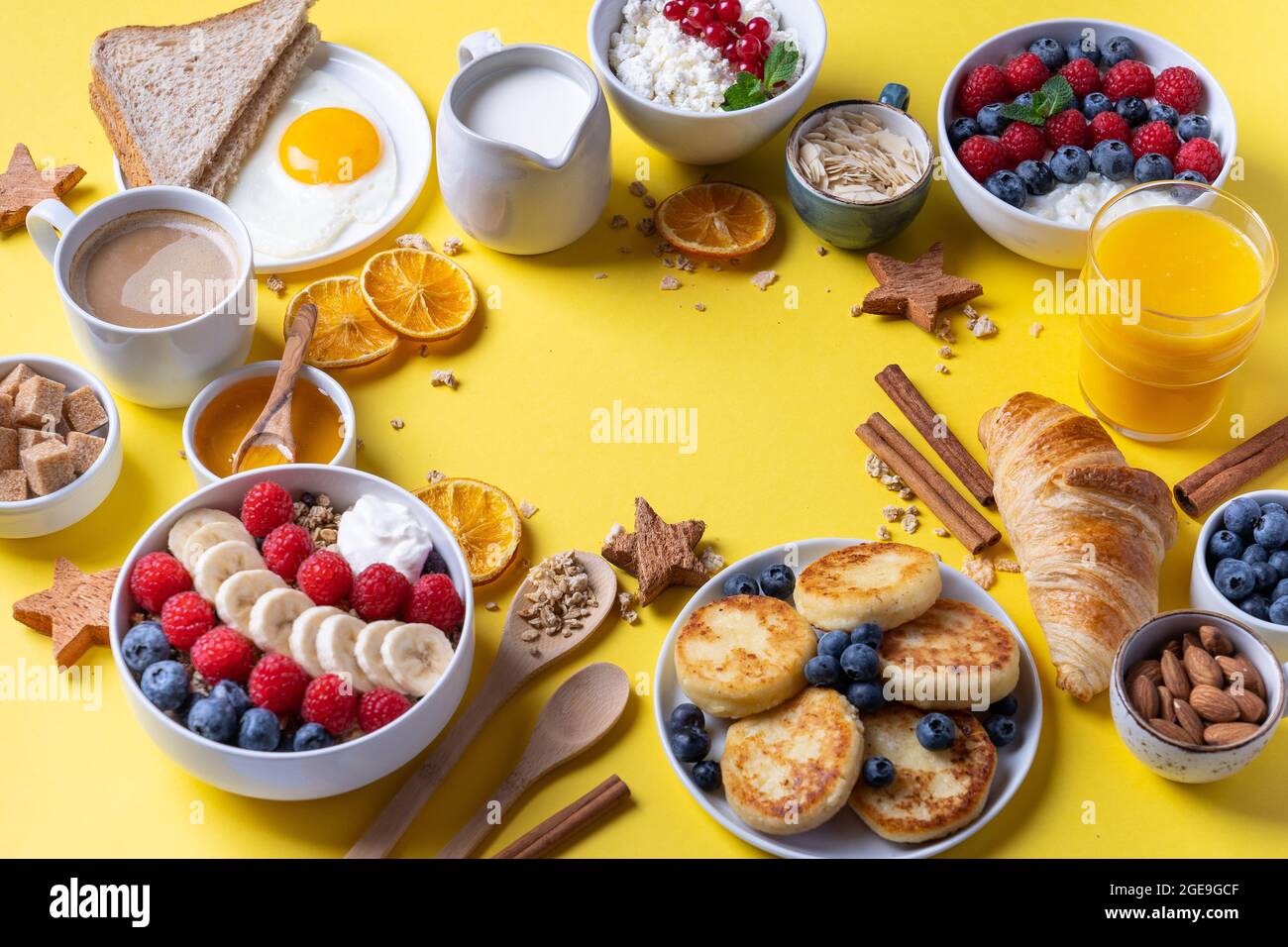 Healthy breakfast table scene with fruit, yogurts, croissants, smoothie ...