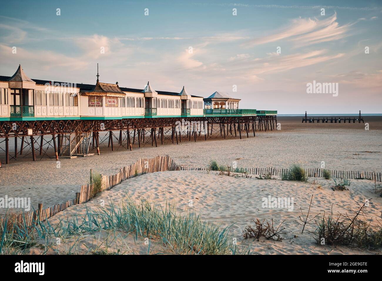 The pier on St Annes Beach lit by the soft light of the evening sun ...