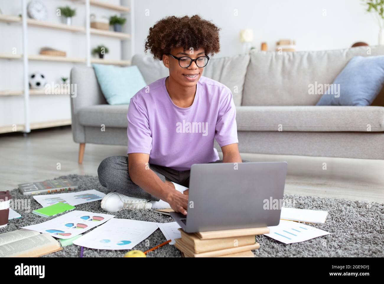 Home education concept. Black teen student working on study project ...