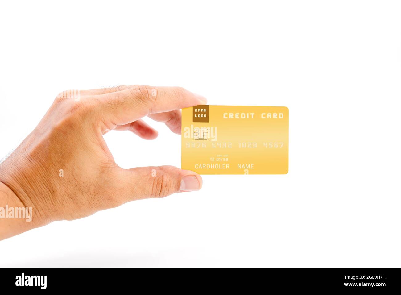 Human hand holding yellow color bank credit card on white background ...
