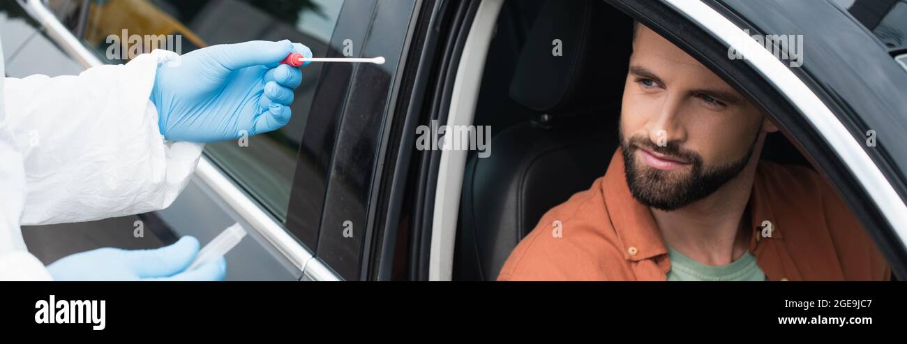 Medical worker holding pcr test near driver in auto, banner Stock Photo ...