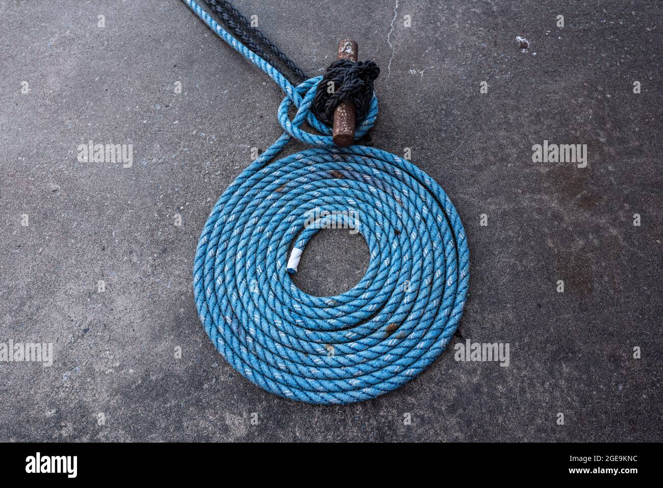 Blue mooring rope laid down in a spiral Stock Photo - Alamy