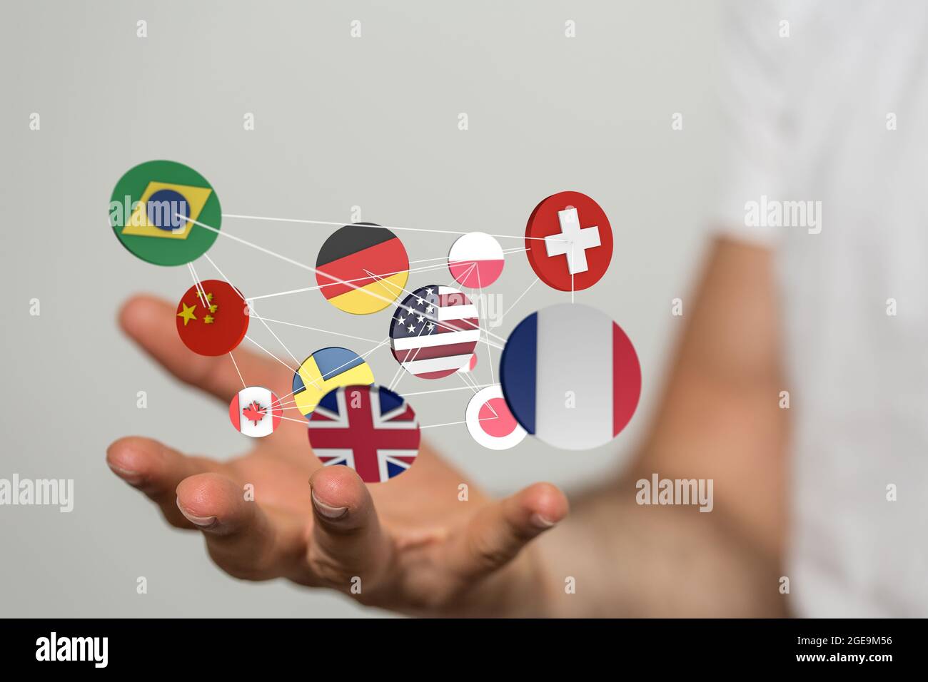 Hand holding connected floating icons of different country flags Stock ...
