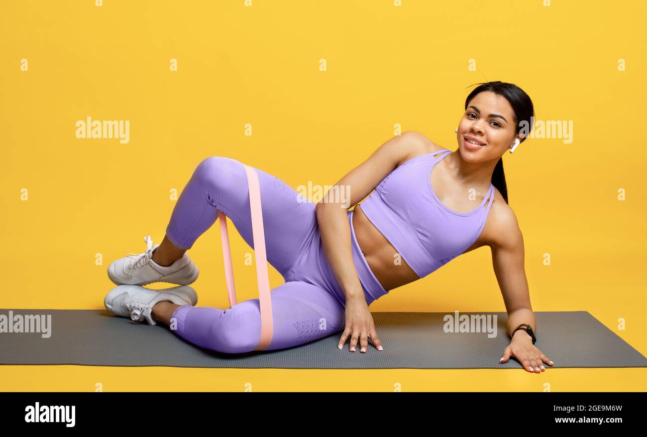 Full length shot of active black woman doing crossfit exercise with ...