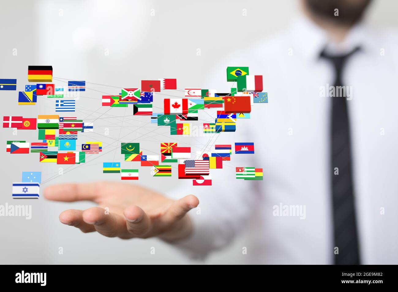 Hand holding connected floating icons of different country flags Stock ...