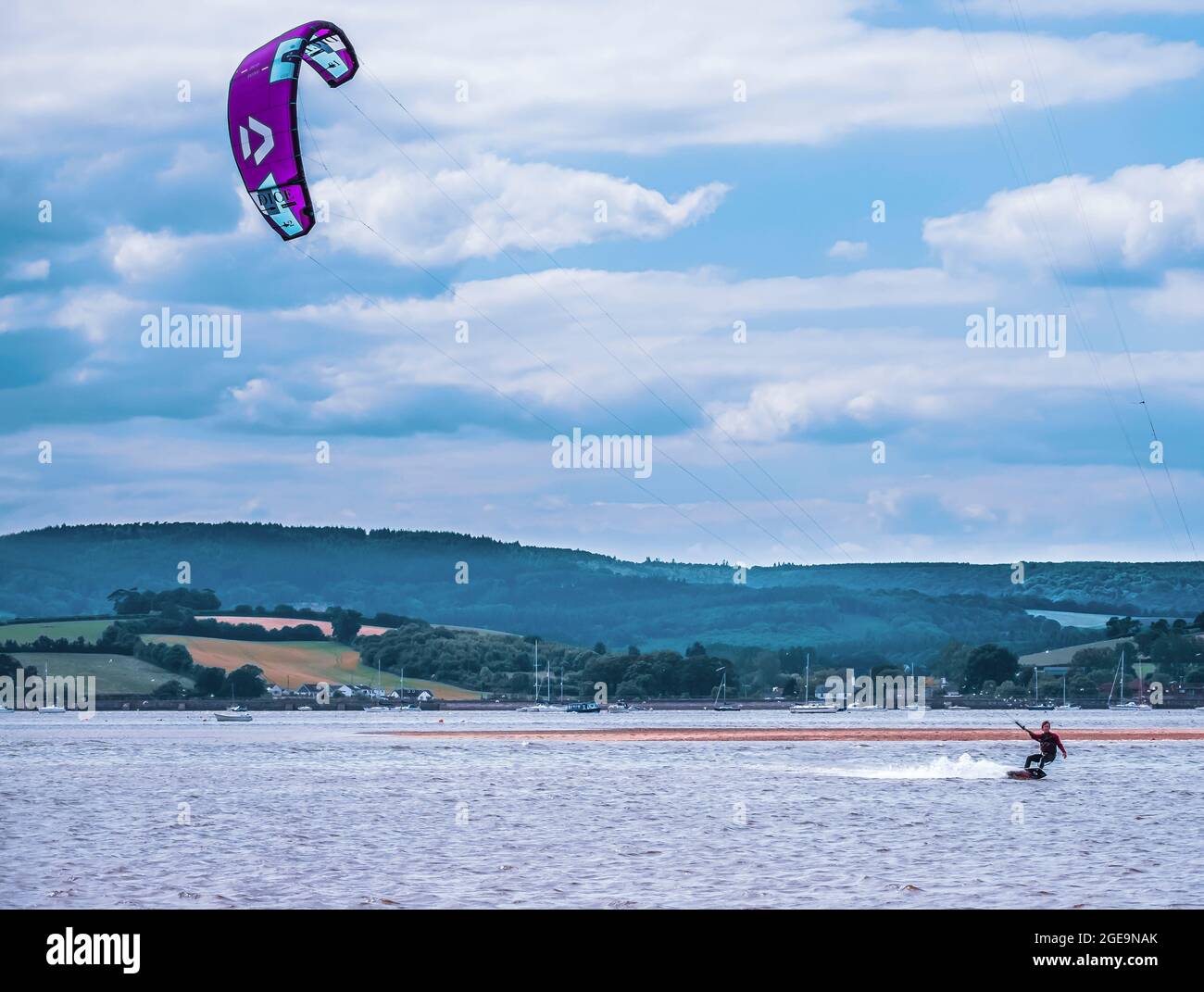 A kite surfer speeds across the river Exe estuary Stock Photo - Alamy