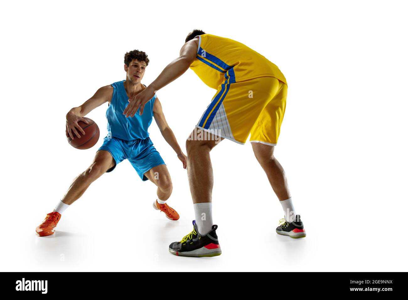 Two male athletes, basketball players in action, motion compete during ...