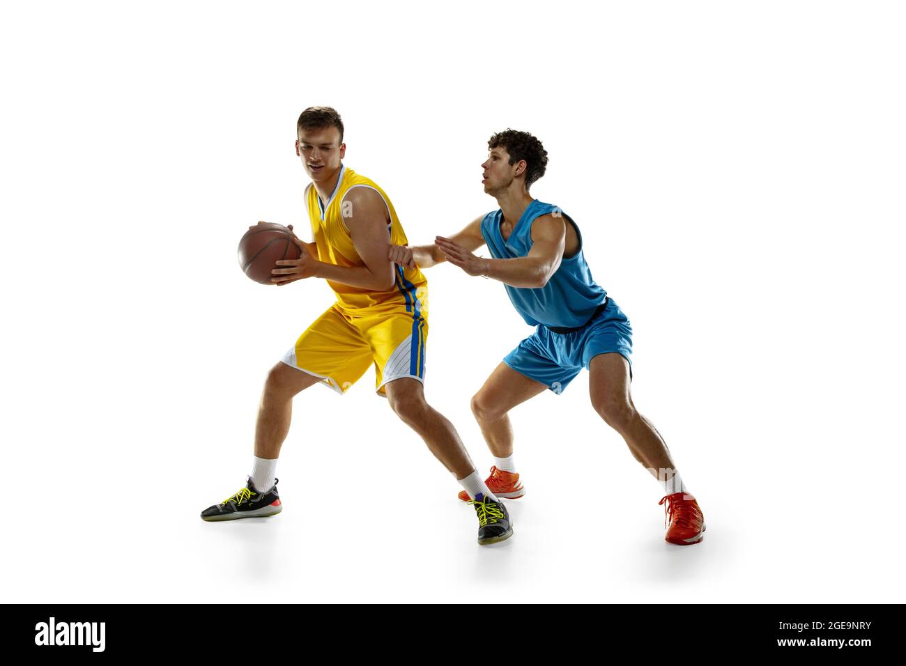 Two male athletes, basketball players in action, motion compete during ...