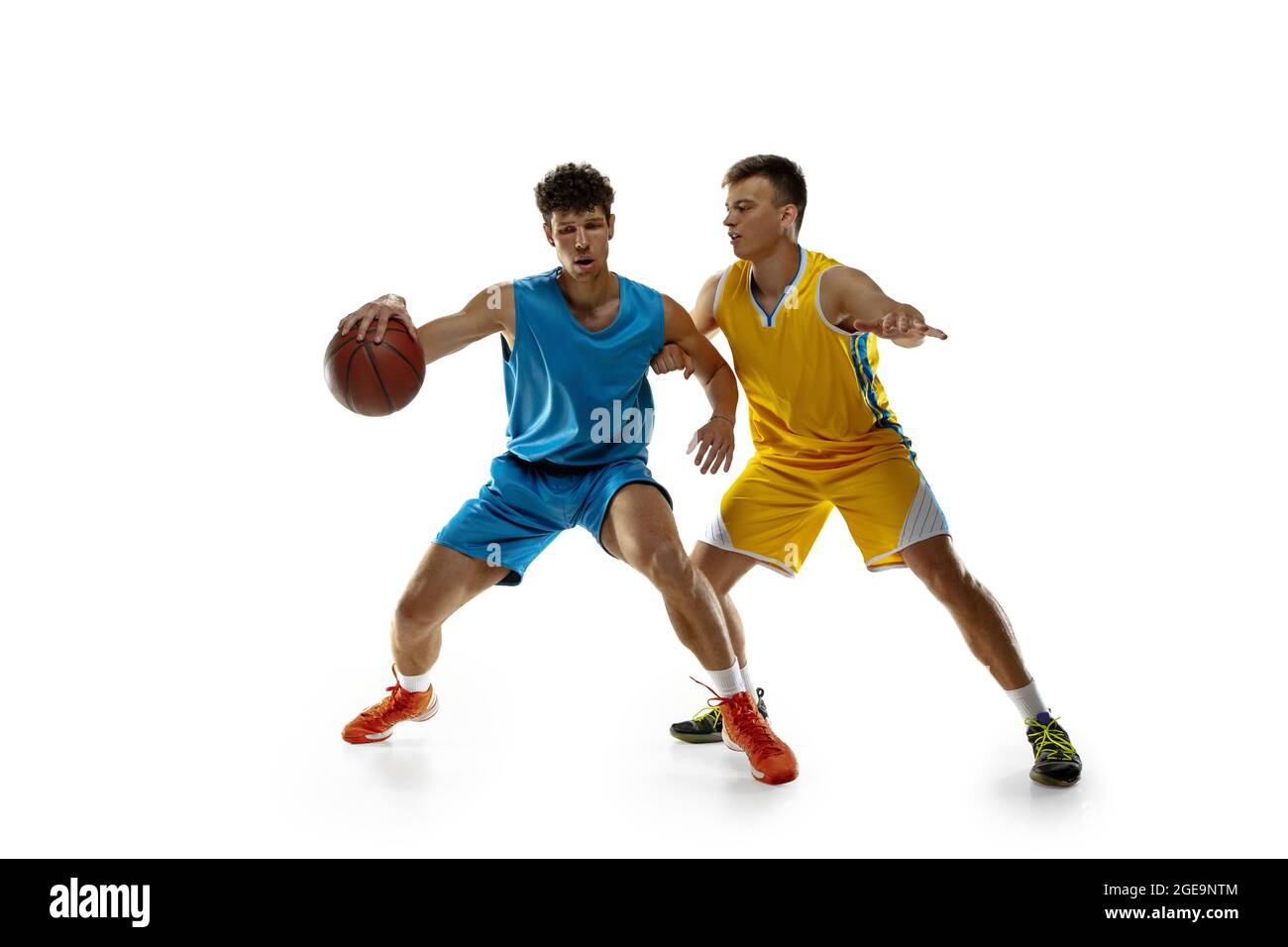 Two male athletes, basketball players in action, motion compete during ...