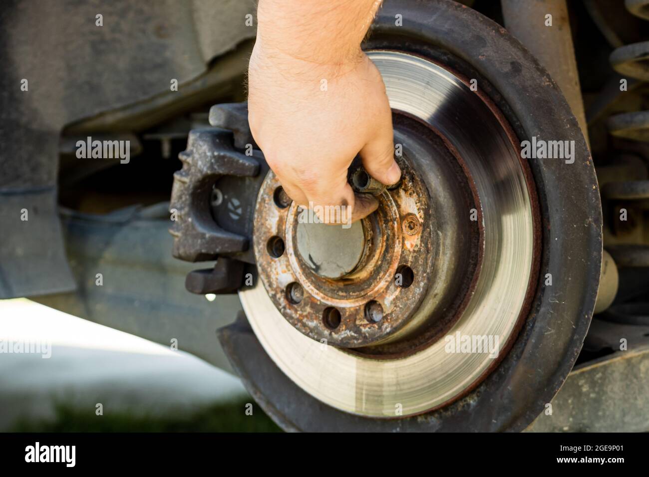 Mechanic cleaning and fixing the brake system of a car in Romania ...