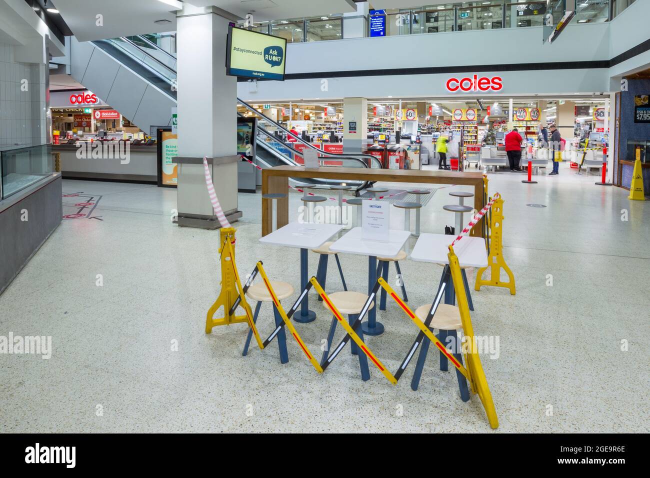 Coronavirus warning signs and cordoned-off public seating in the ...