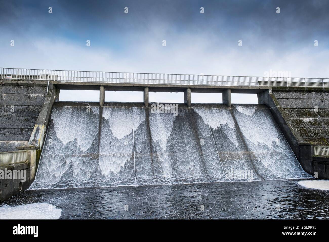 Water flowing down the overflow spillway of Crowdy Reservoir on Bodmin ...