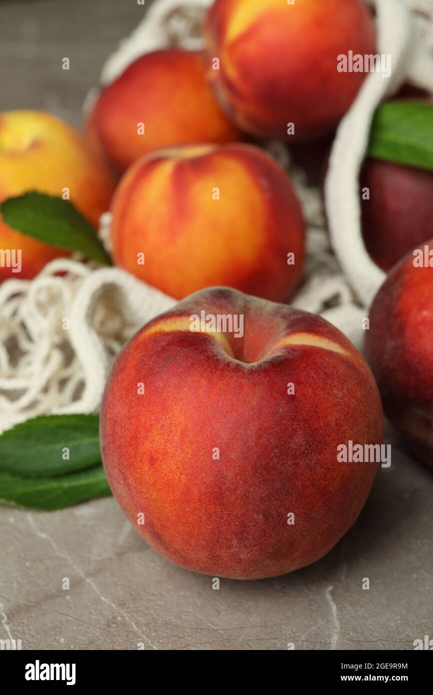String bag with peach fruits on gray textured table Stock Photo - Alamy