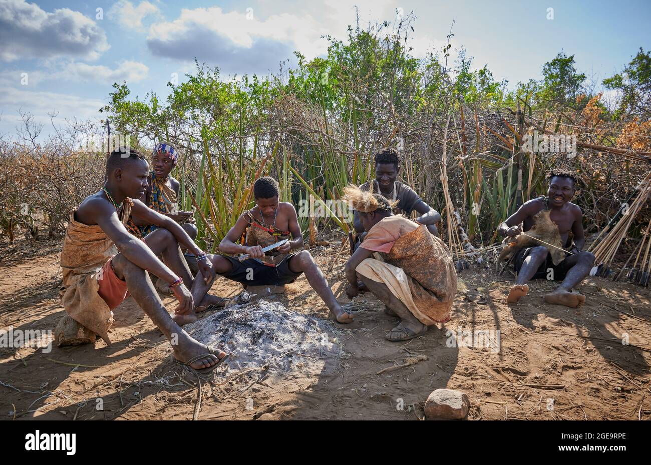 bushmen of Hadzabe tribe sitting around a fireplace, Lake Eyasi ...