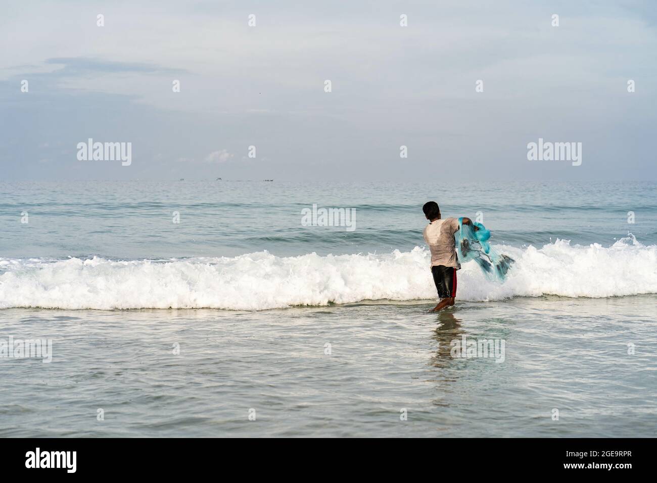 Fisherman cast a net at the beach Stock Photo - Alamy