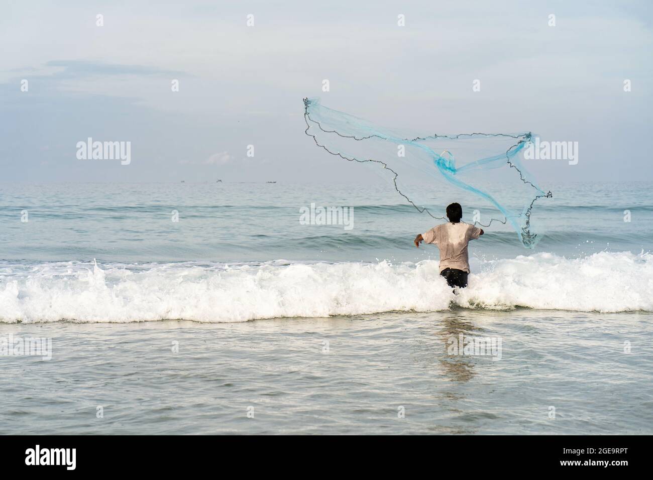 Fisherman cast a net at the beach Stock Photo - Alamy