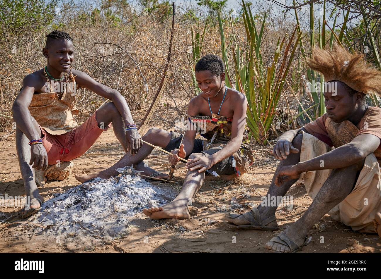 bushmen of Hadzabe tribe sitting around a fireplace, Lake Eyasi ...