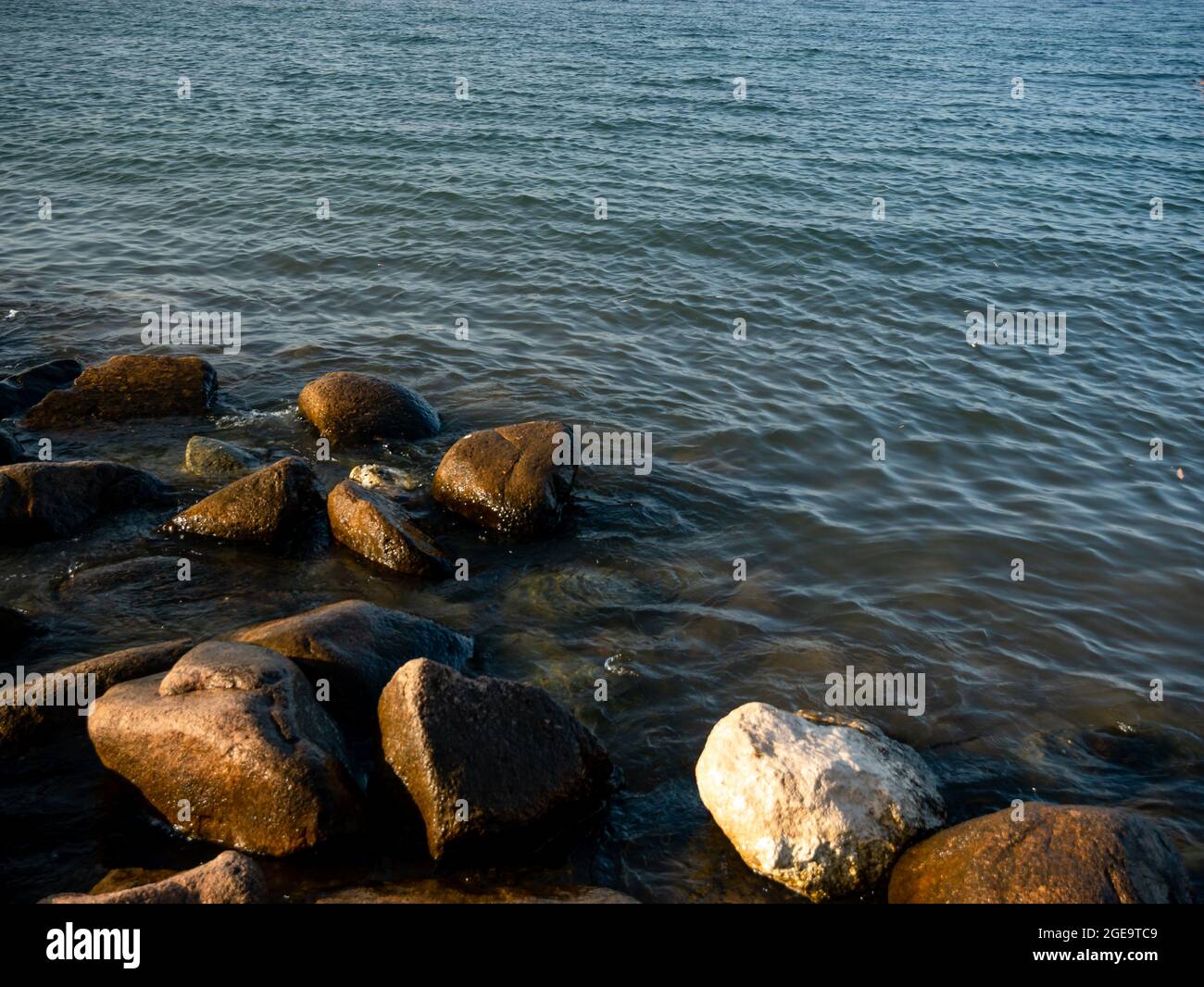 calm sea and rocks along the coast Stock Photo - Alamy
