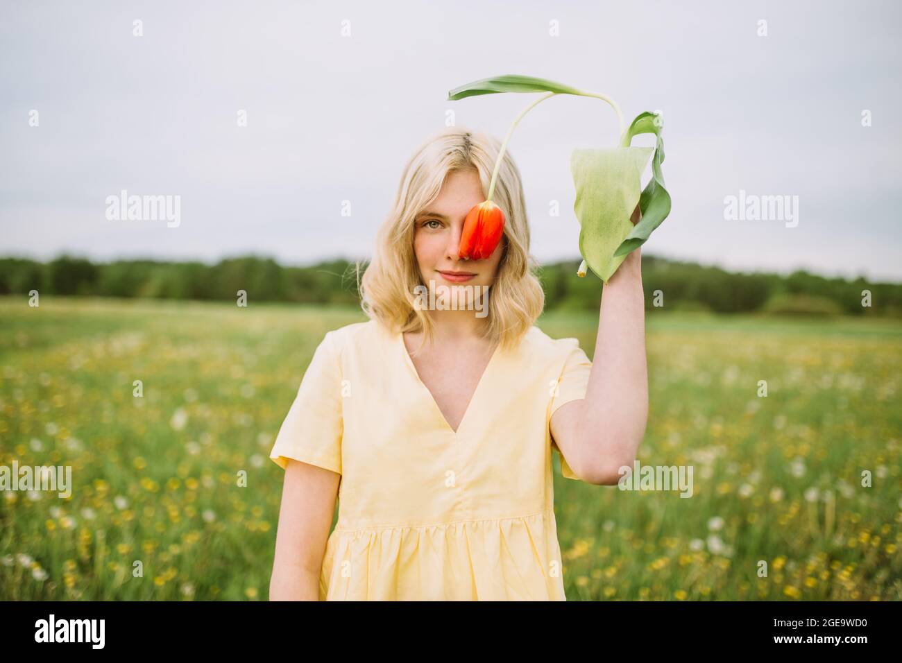 Woman covering an eye with flower hi-res stock photography and images ...