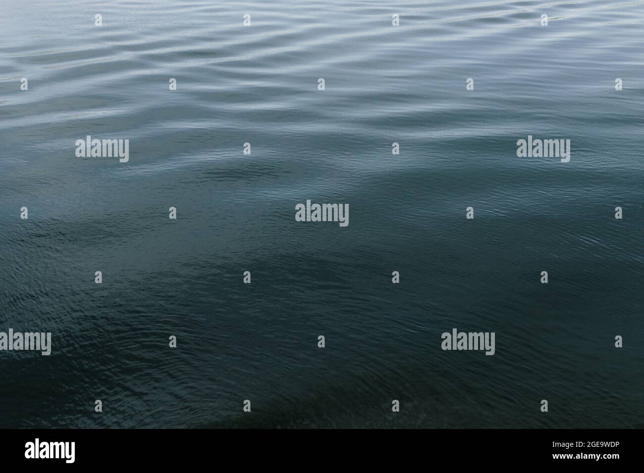 High angle of abstract background of rippling surface of pond with calm ...