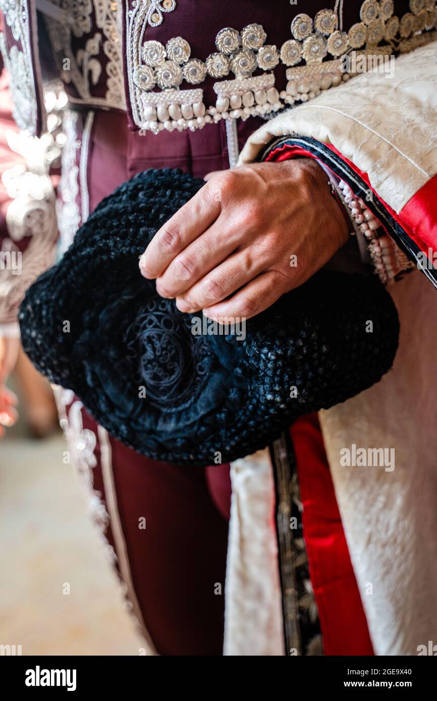 Crop unrecognizable bullfighter in traditional red costume and with ...