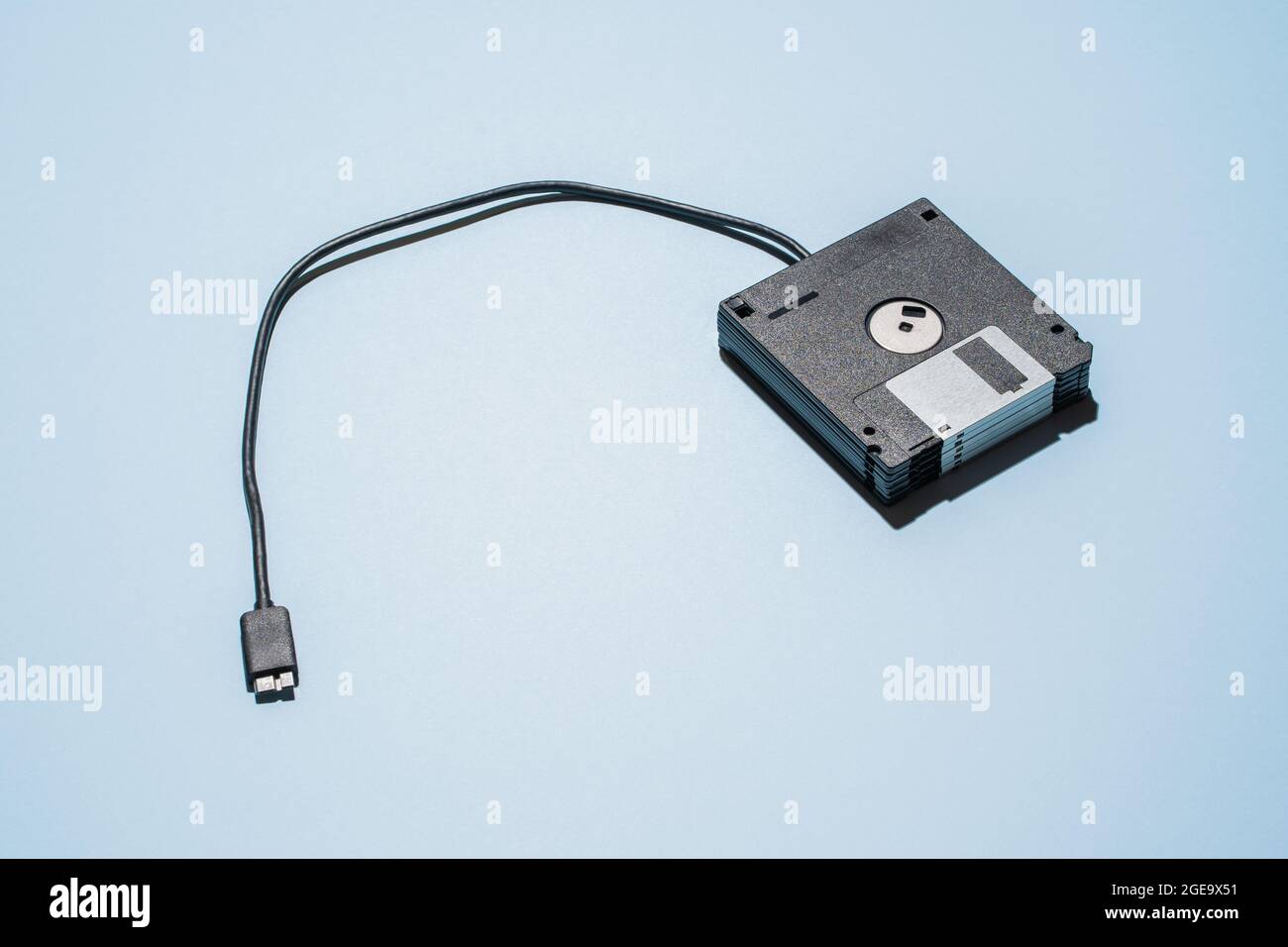 From above of stack of black floppy disks with usb cable placed on ...